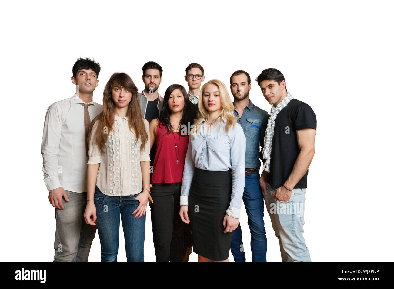 Portrait of multiethnic group of friends standing together over colored ...
