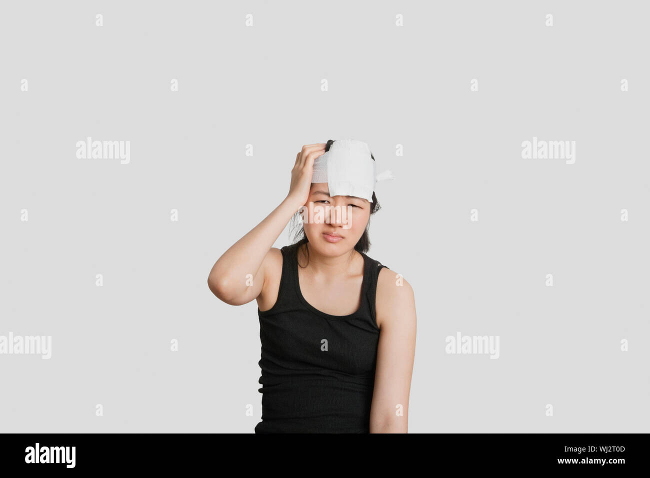 Portrait of a young female in pain with serious head injury Stock Photo ...