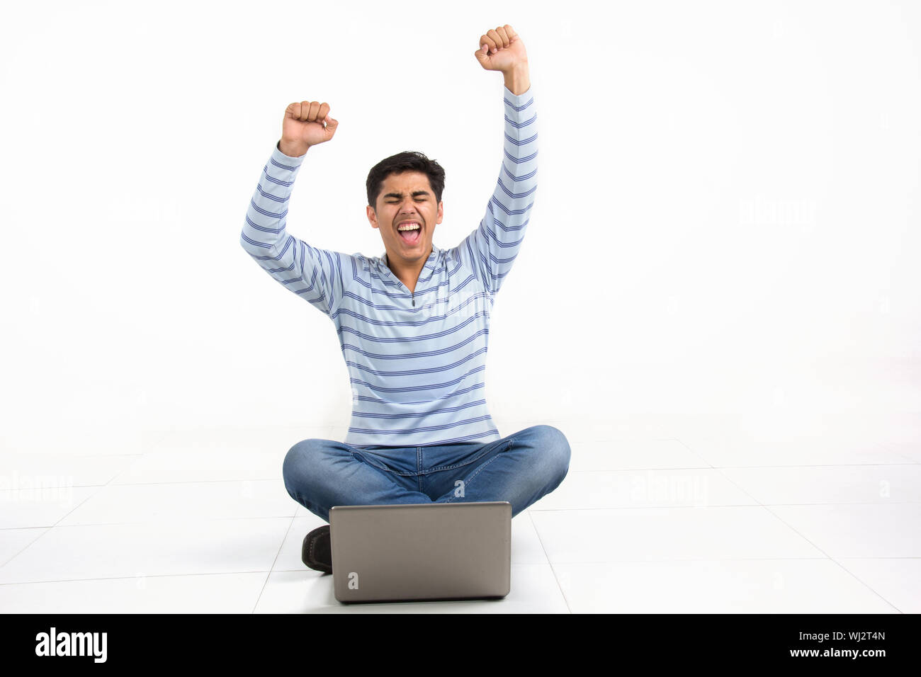 Man celebrating success on laptop hi-res stock photography and images ...