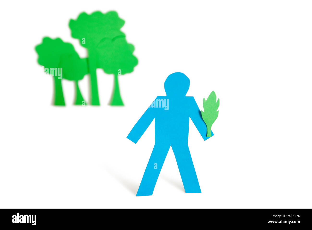 A blue stick figure holding a leaf representing concept of nature ...