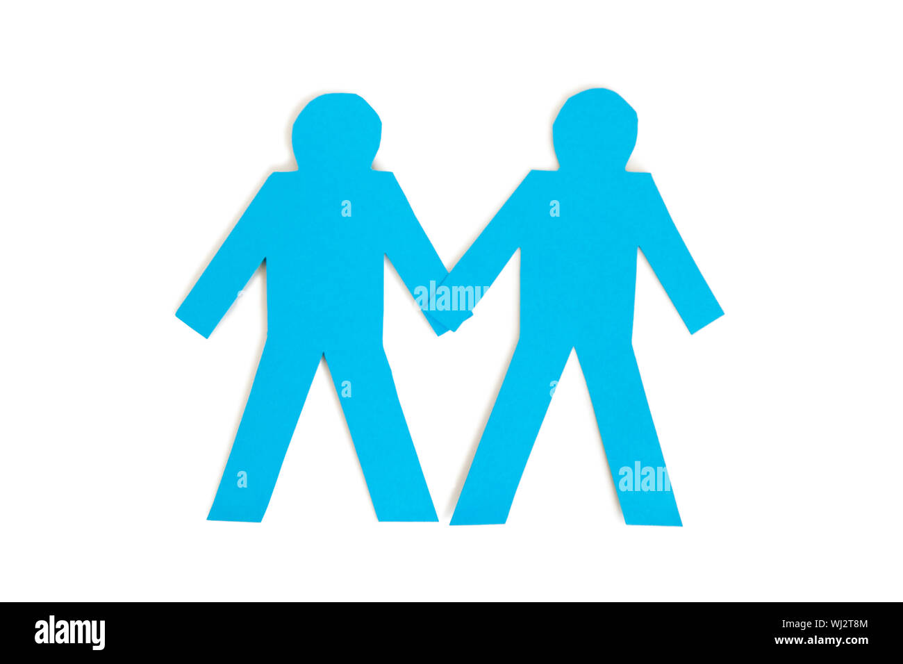 Two blue paper stick figures holding hands over white background Stock ...