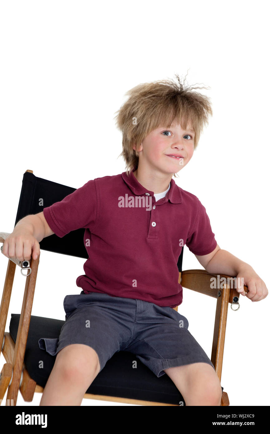 School boy sitting on director's chair over white background Stock ...