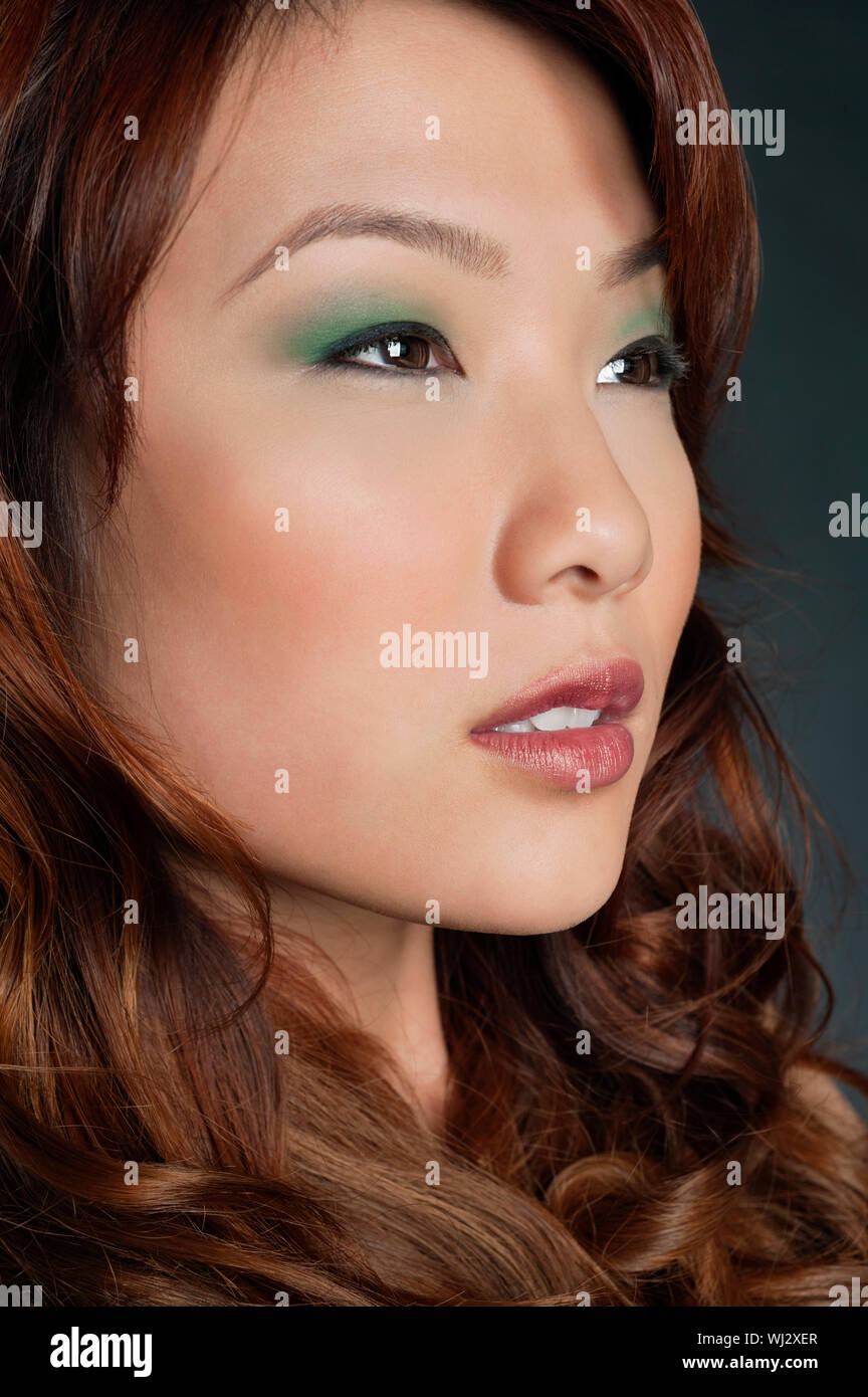 Beautiful Chinese woman with makeup looking away Stock Photo - Alamy