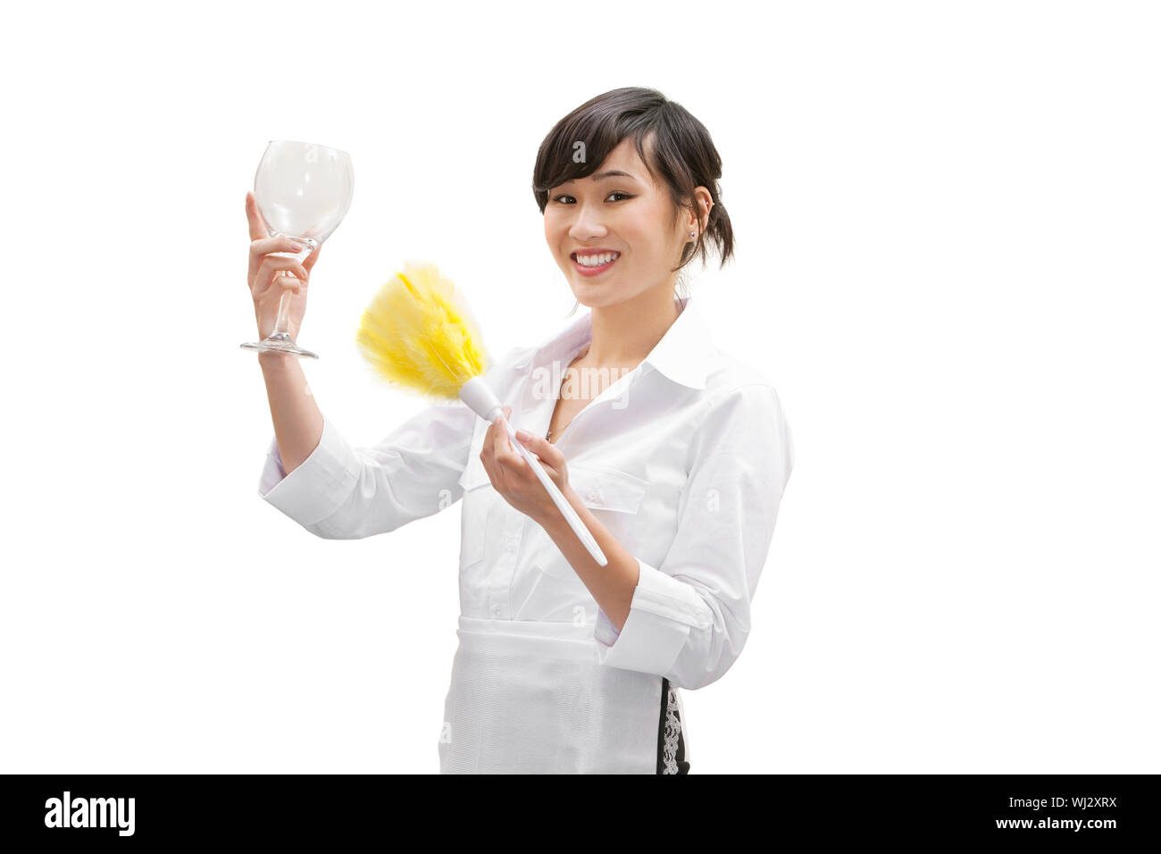 Portrait of a happy female house cleaner dusting glass with feather ...