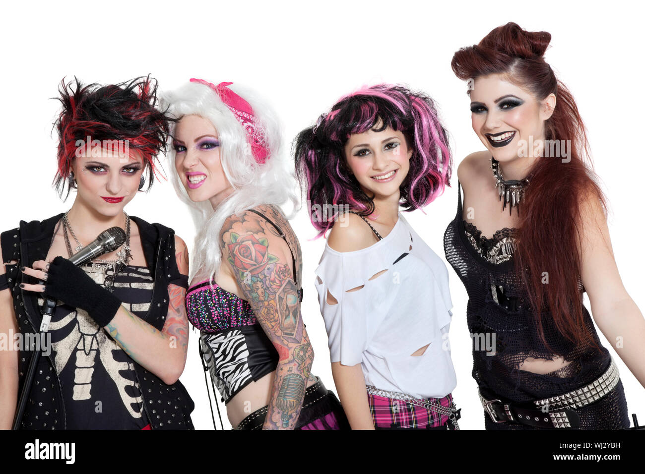 Portrait of all female rock band with microphone over white background ...