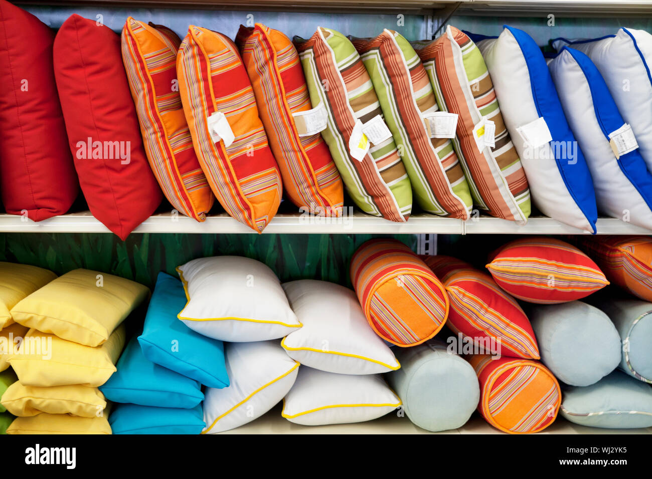 Multicolored cushions on display in store Stock Photo - Alamy