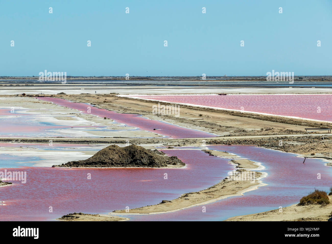 The Salin-de-Giraud salt farm with pink purple salty sea water in man ...