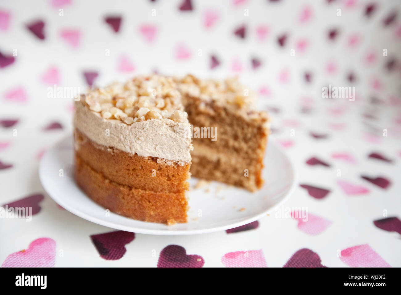 Close-up of cake with missing piece over heart shaped background Stock Photo - Alamy