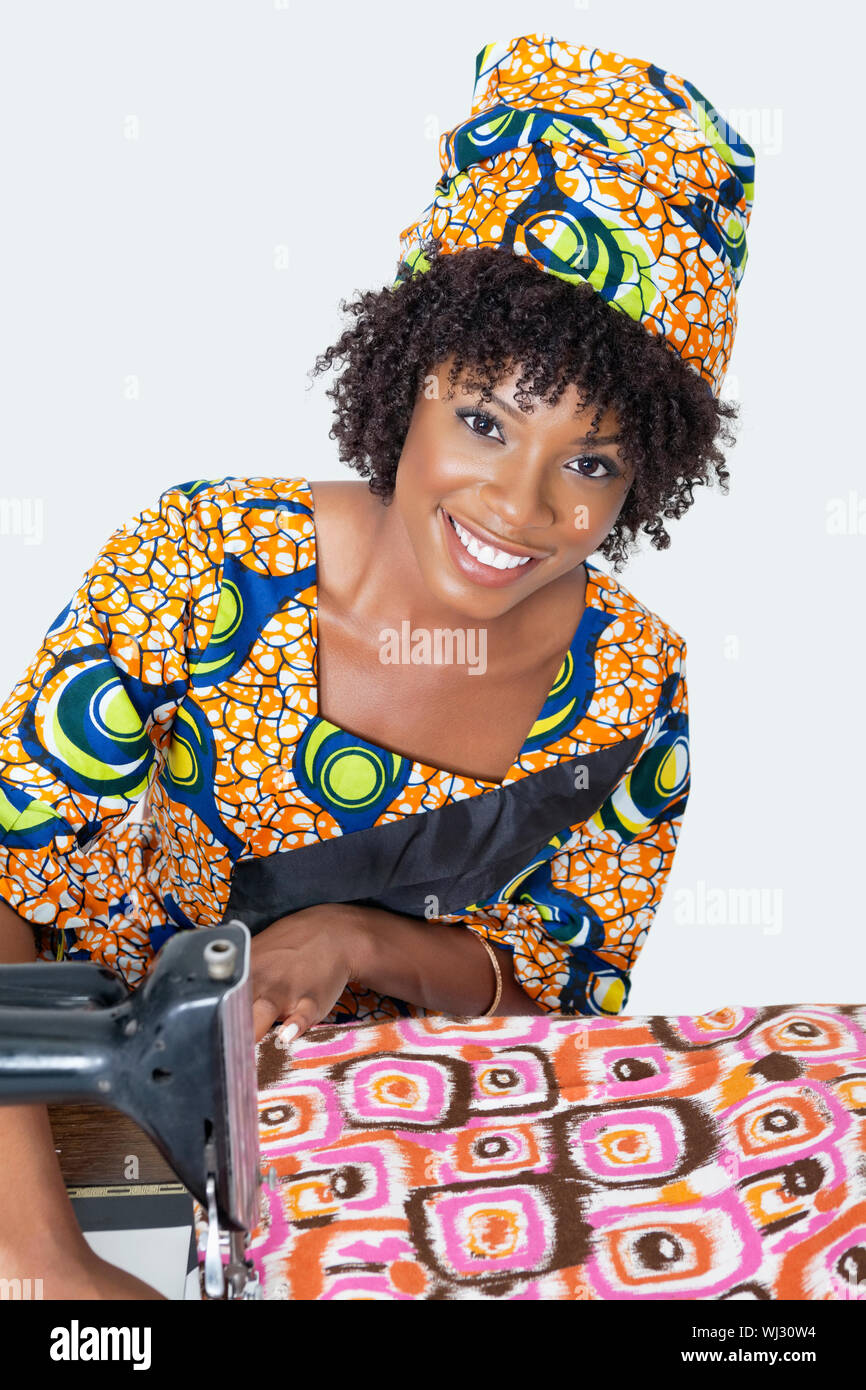 Portrait of an African American female fashion designer sewing fabric ...