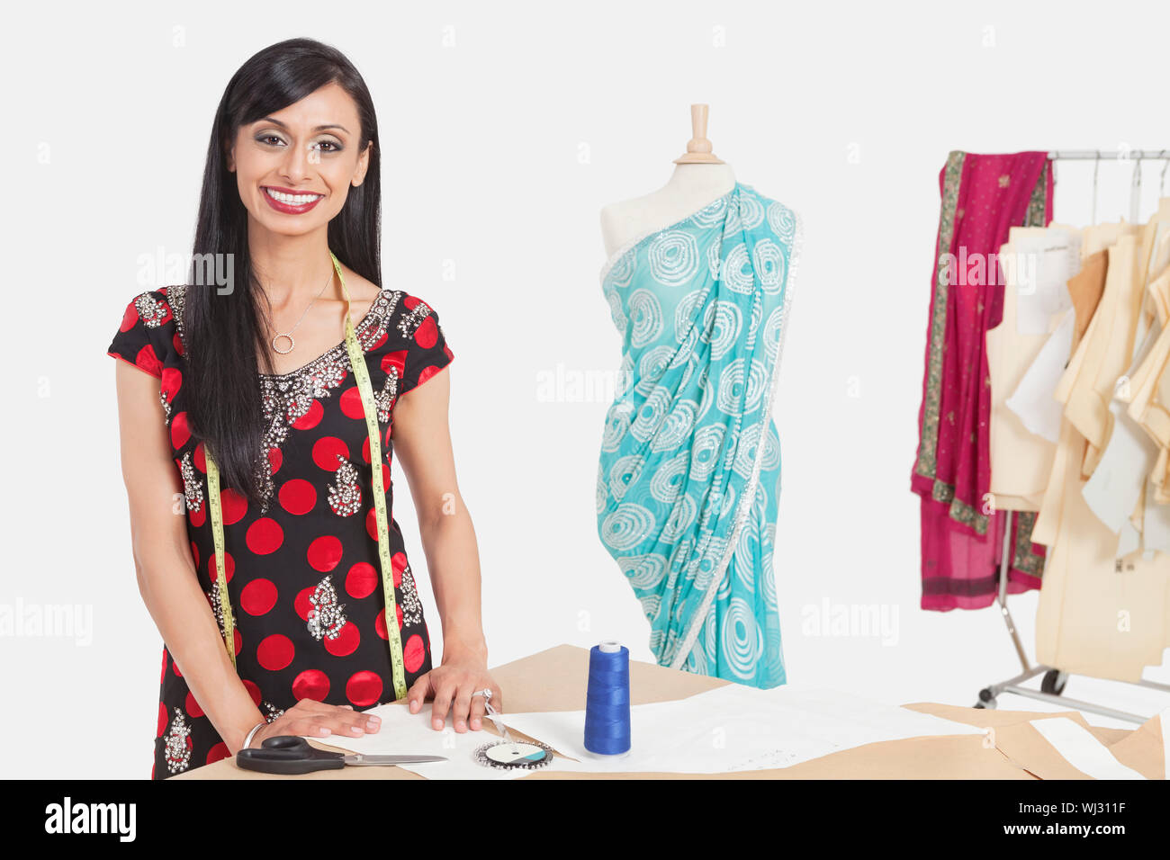 Portrait of beautiful Indian female tailor smiling Stock Photo - Alamy