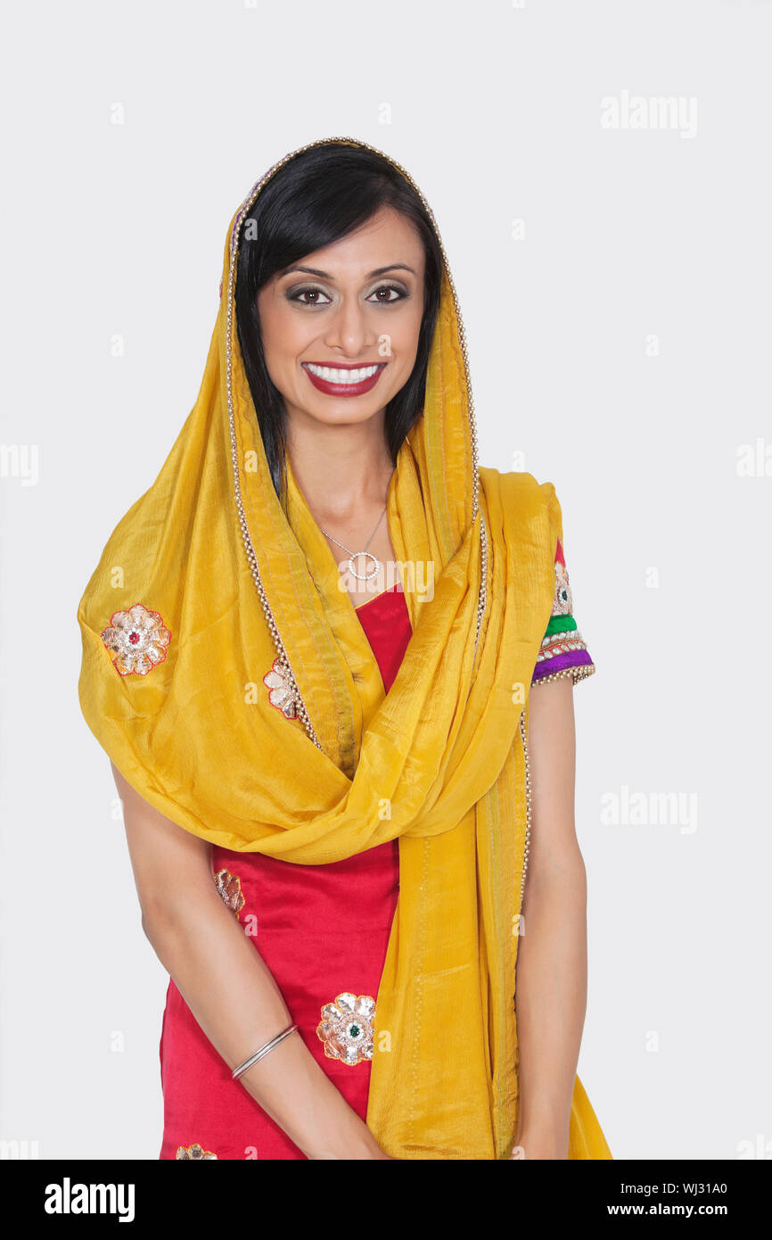 Portrait of an attractive Indian female in traditional wear standing ...