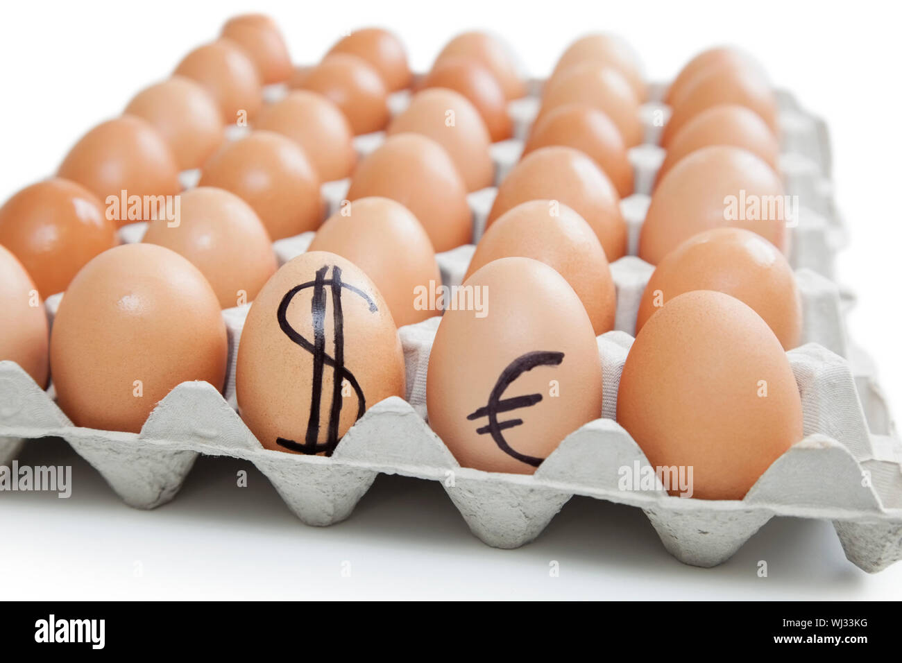 Brown eggs in carton with dollar and euro sign over white background ...