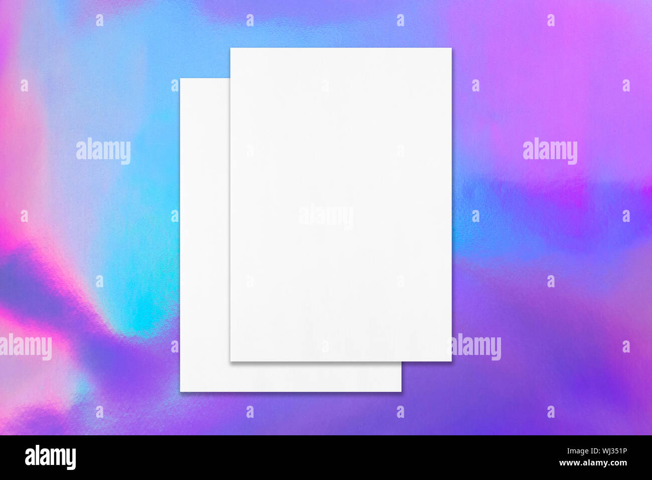 Two empty white rectangle poster mockups lying on top of each other ...