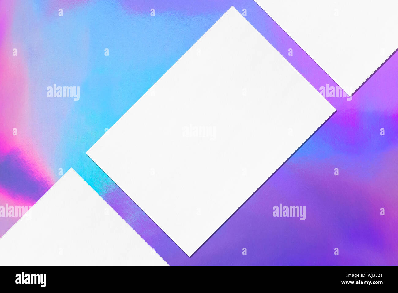 Close up of three empty white rectangle poster mockups lying diagonally ...