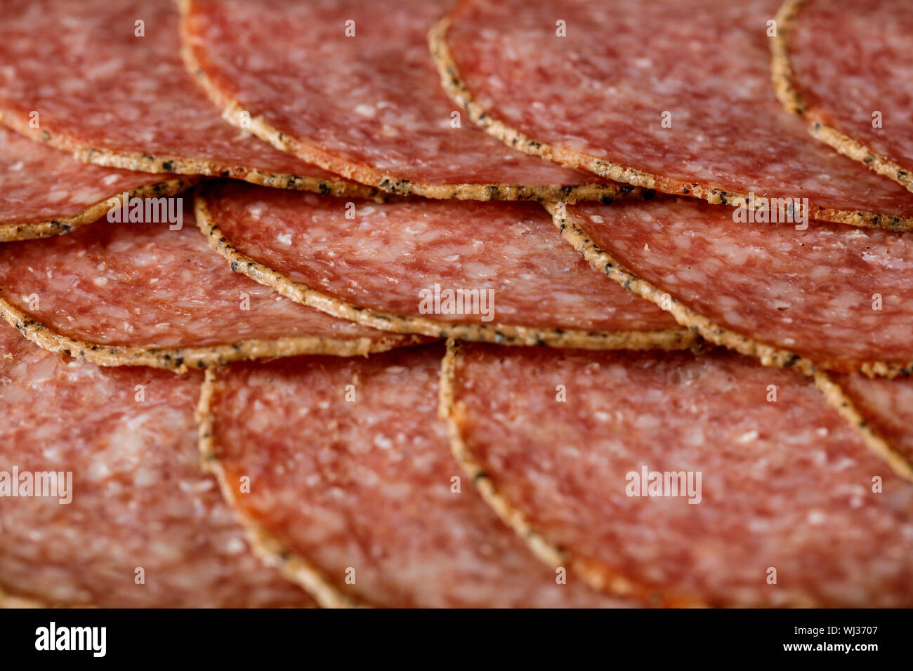 delicious sliced salami sausage . top view Stock Photo - Alamy
