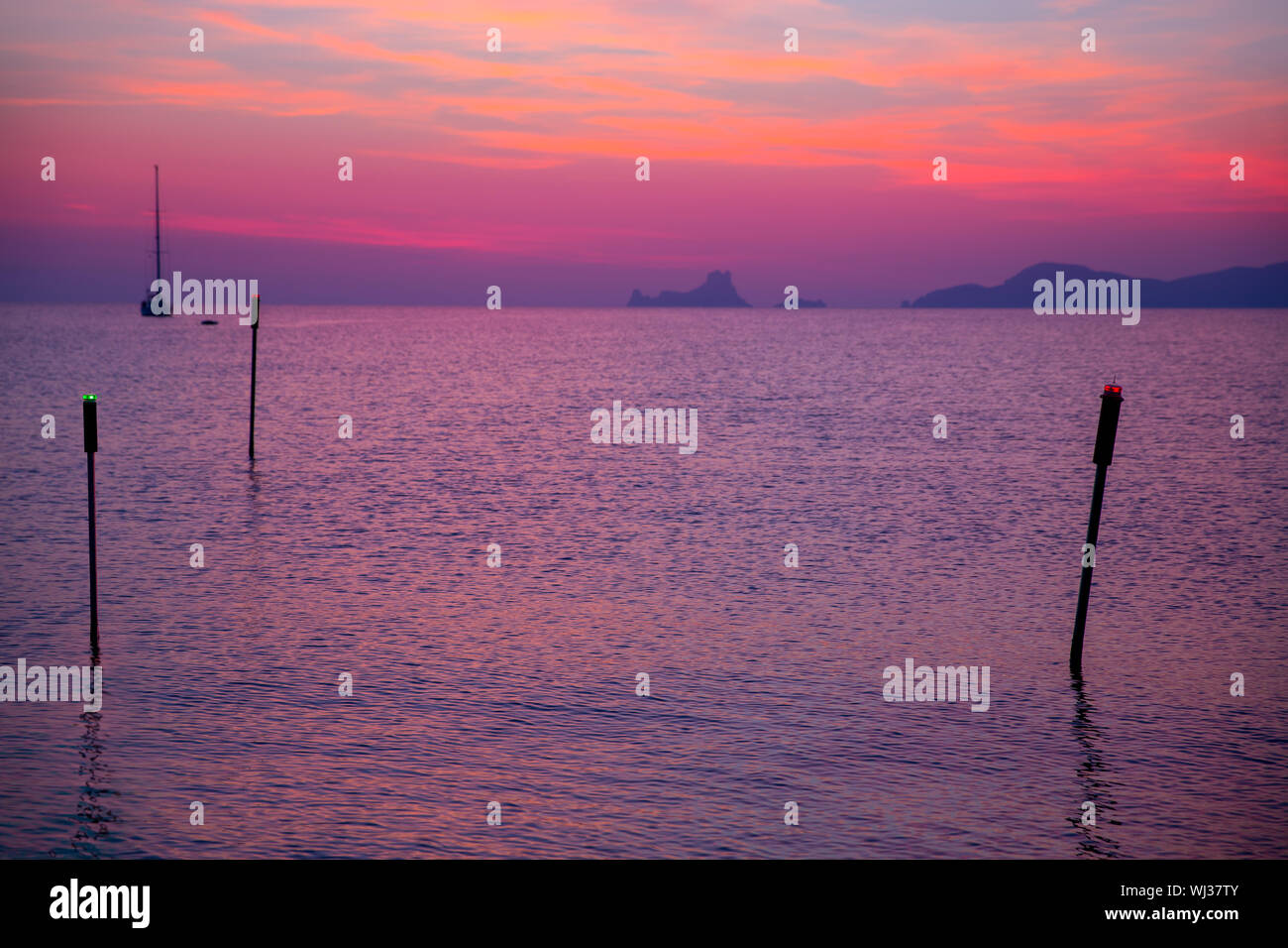 Ibiza sunset view from formentera Island with sailboat in Balearic ...