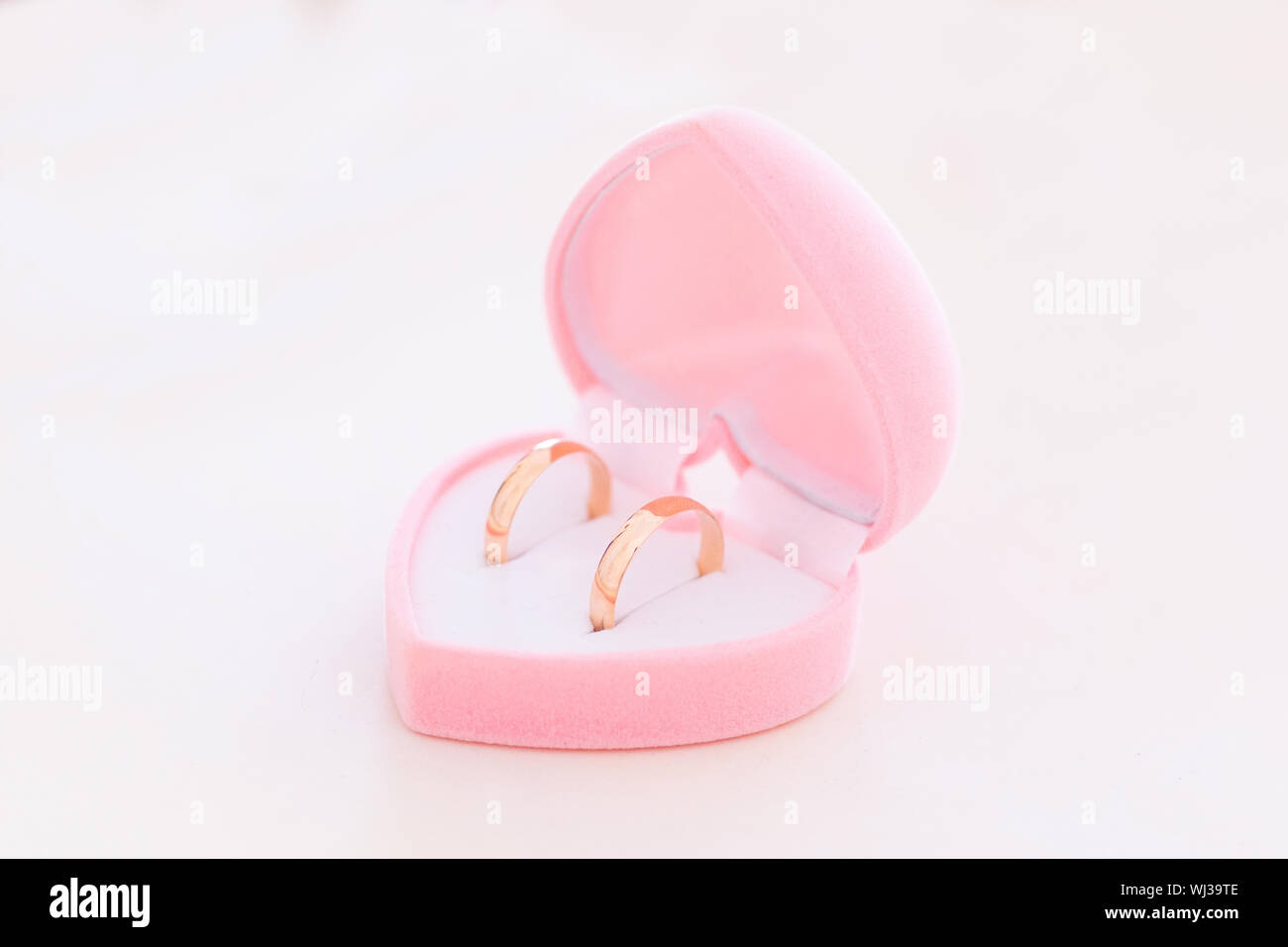 Two become one symbol of marriage, are rings in red heart shaped box ...