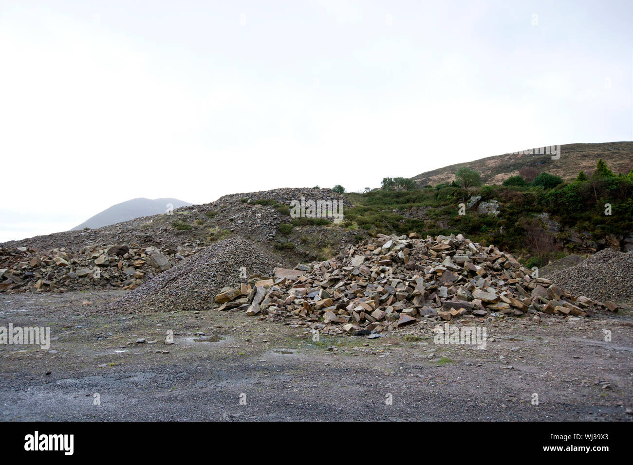 Piles of rocks in small quarry Stock Photo - Alamy
