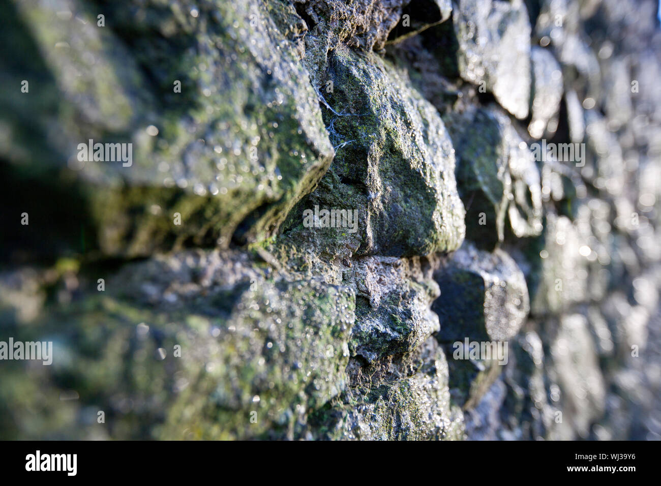Stone wall glints in sunlight Stock Photo - Alamy