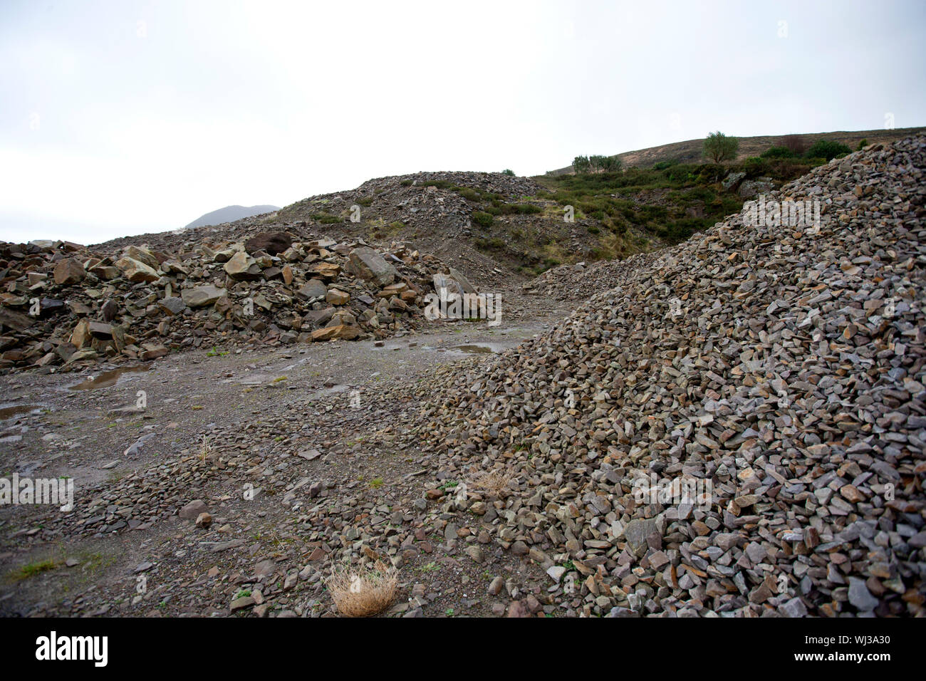 Piles of rock in quarry Stock Photo - Alamy