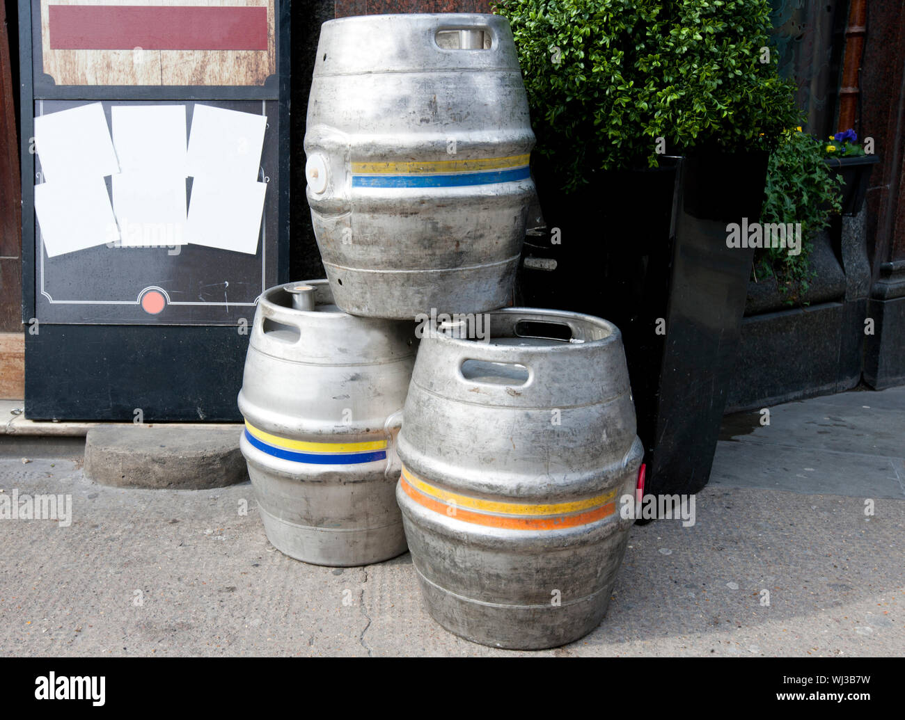 Three empty metal kegs outside a bar Stock Photo - Alamy