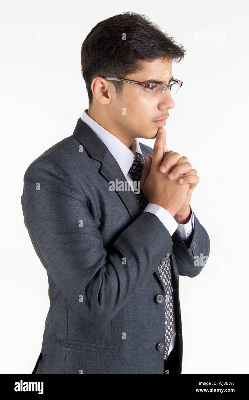 Side profile of a businessman thinking with his hand on chin Stock ...