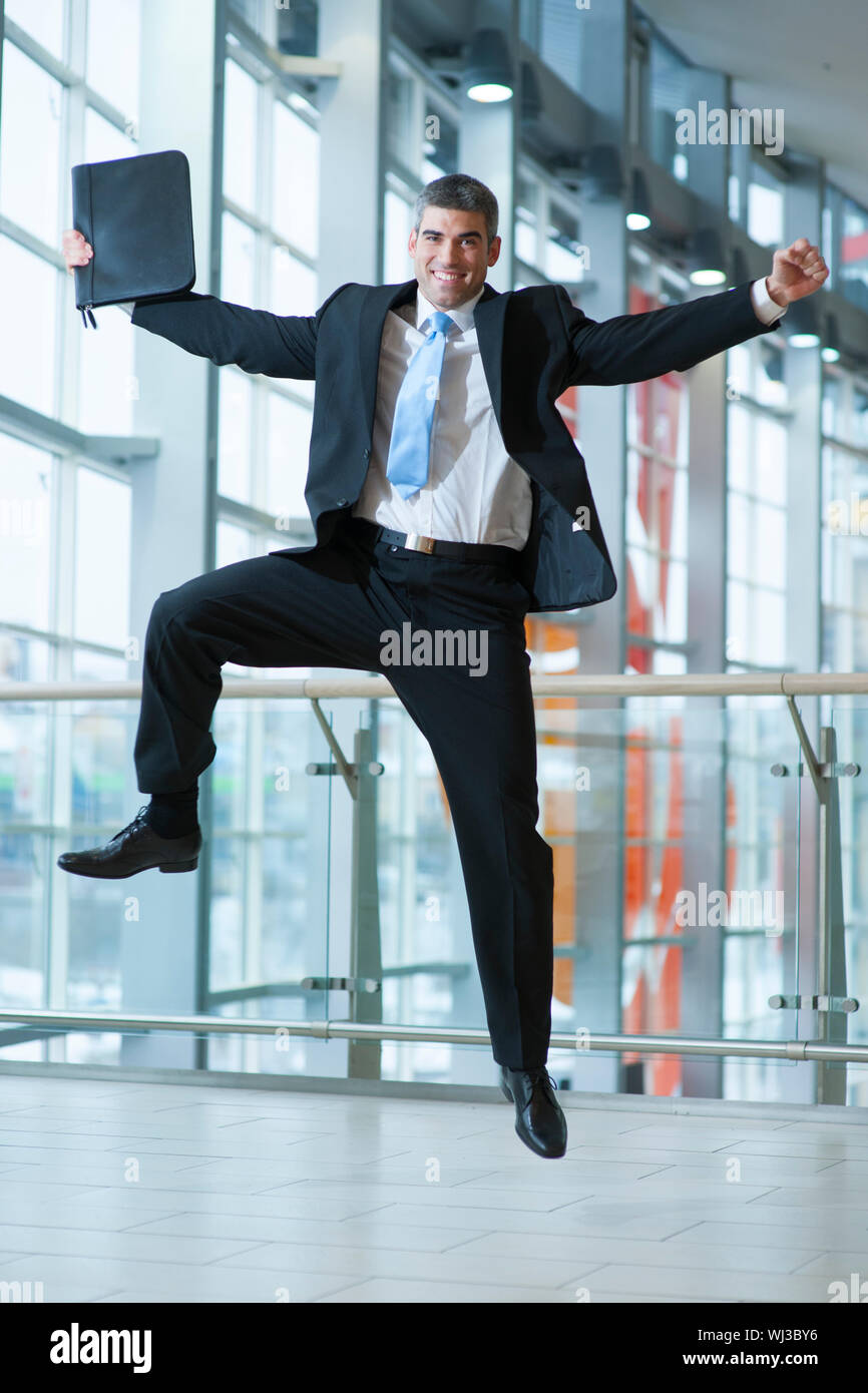 Happy Businessman leaps into the air Stock Photo - Alamy