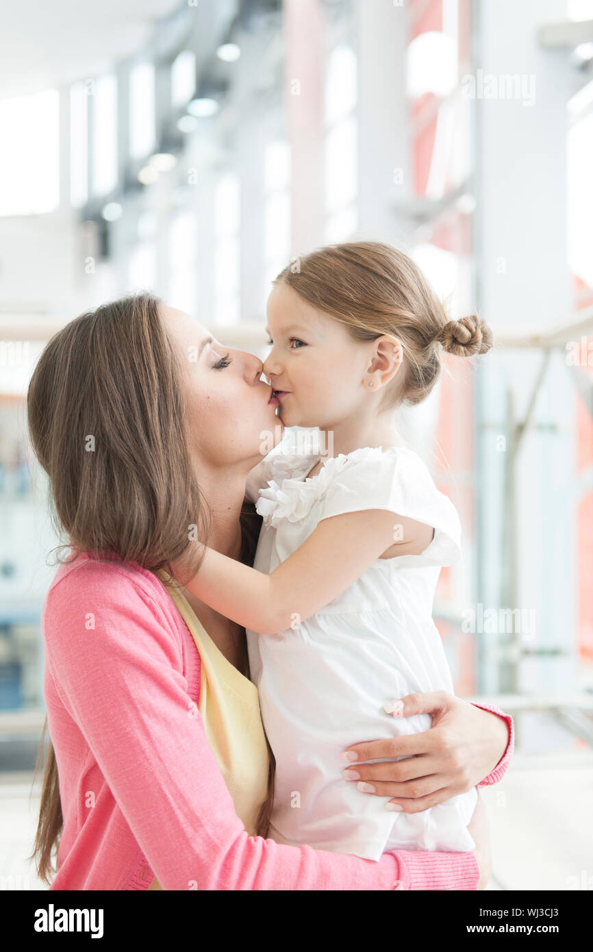 Mother and daughter hug and kiss Stock Photo - Alamy