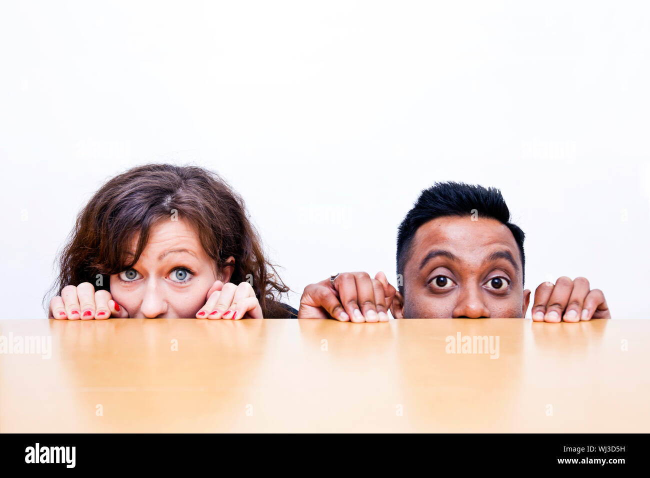 Woman peeking table hi-res stock photography and images - Alamy