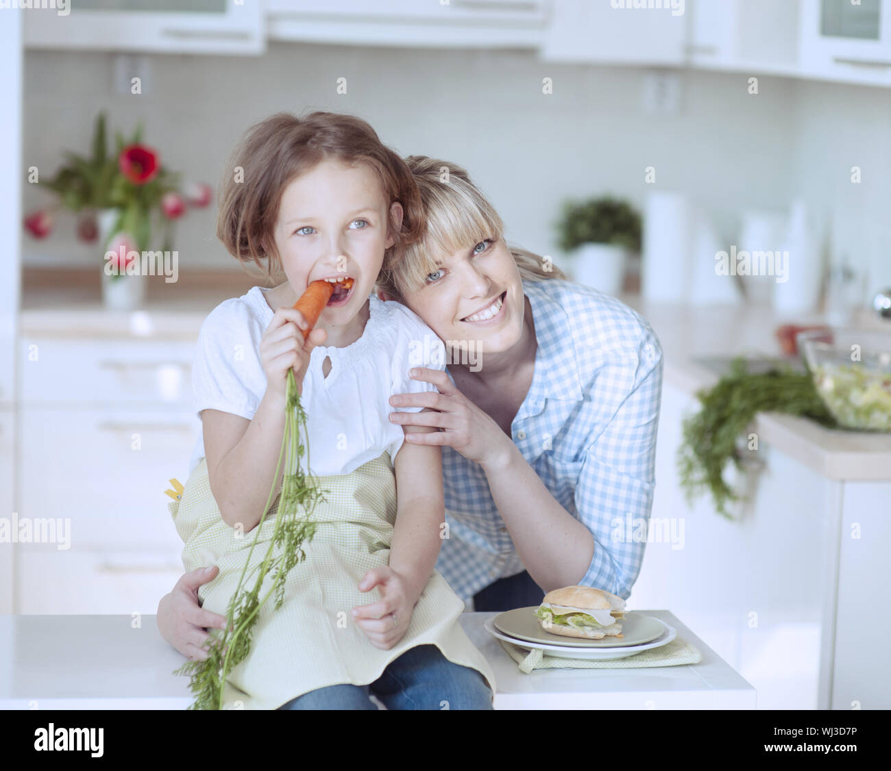 Young girl eating carrot Stock Photo - Alamy