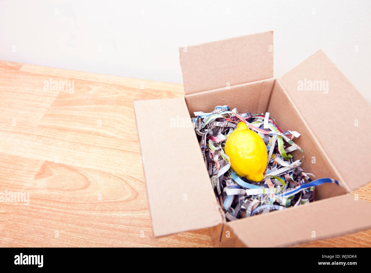 Lemon wrapped up in a box Stock Photo - Alamy