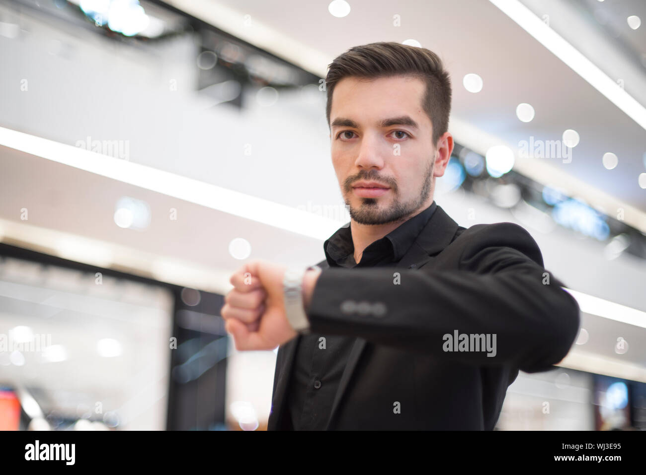 man looks at the clock in the building Stock Photo - Alamy