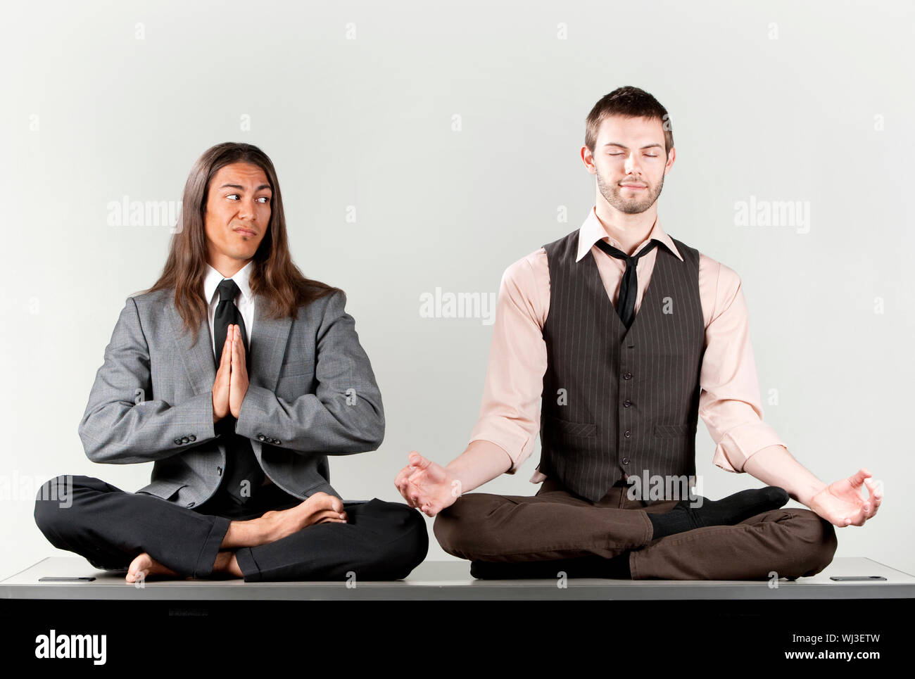Two businessmen meditating on their office desk Stock Photo - Alamy Two businessmen meditating on their office desk Stock Photo - Alamy