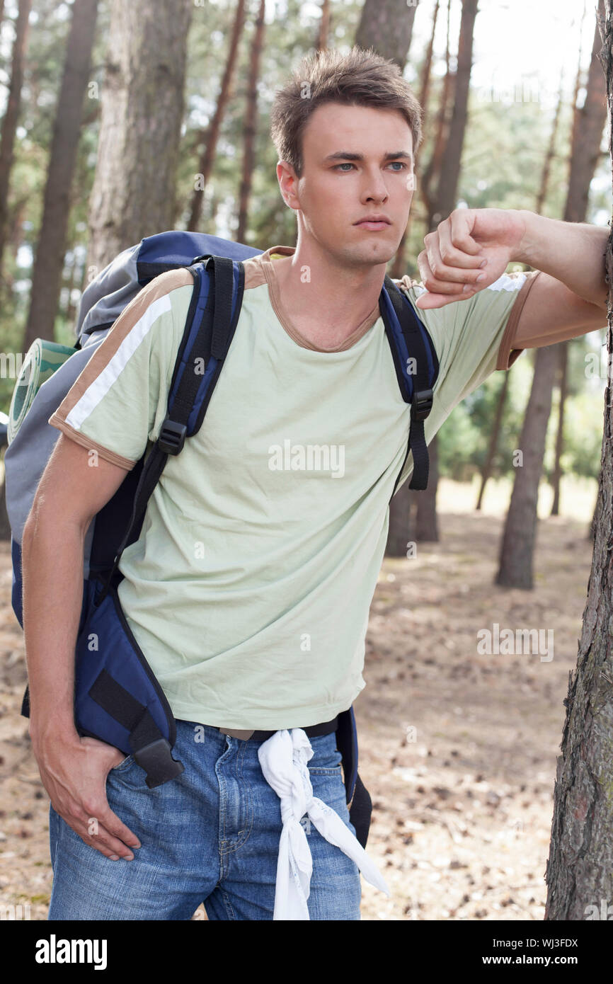 Thoughtful young man with backpack in woods Stock Photo - Alamy Thoughtful young man with backpack in woods Stock Photo - Alamy