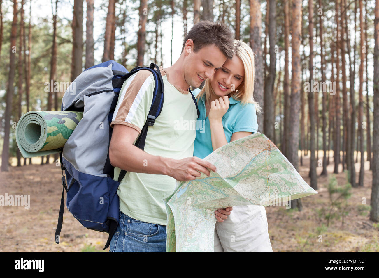Two young men reading map forest hi-res stock photography and images ...