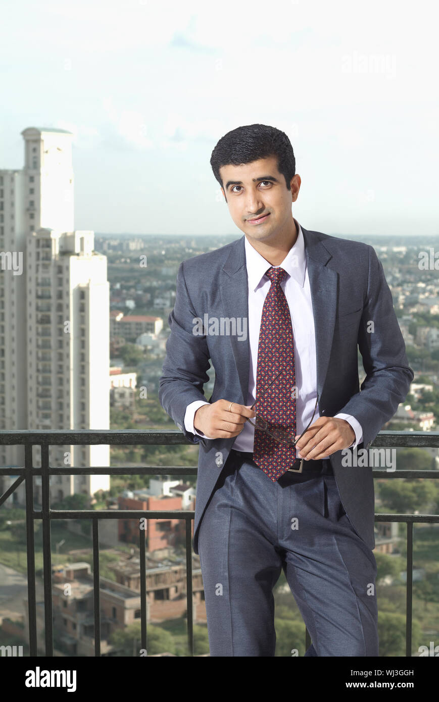 Businessman standing in a balcony Stock Photo - Alamy