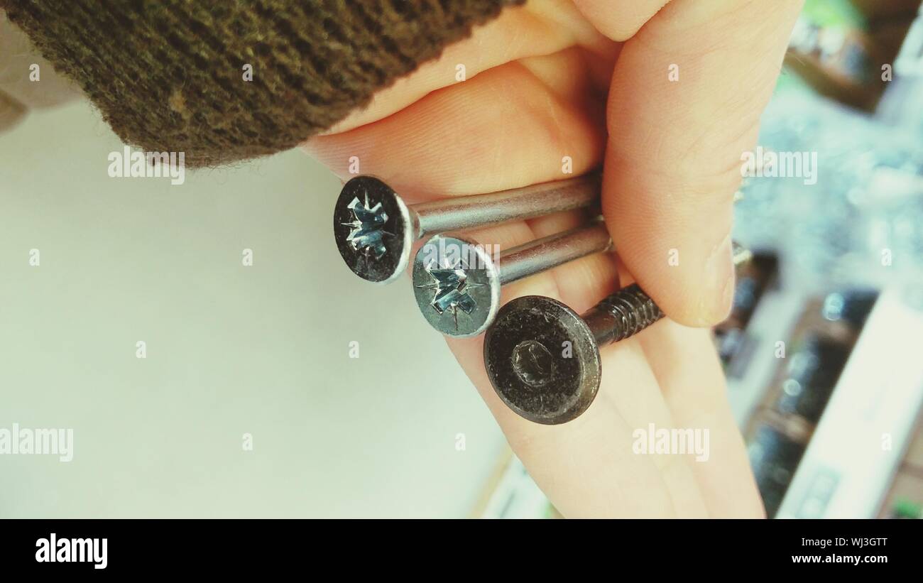 Hand holding screws hi-res stock photography and images - Alamy