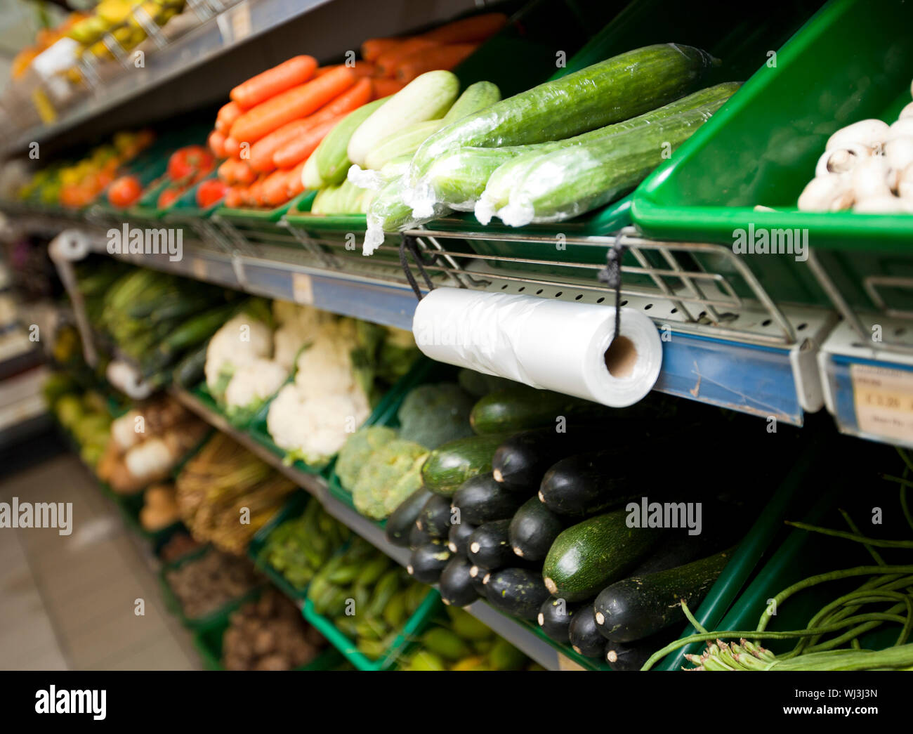Variety of vegetables on shelves in grocery store Stock Photo - Alamy