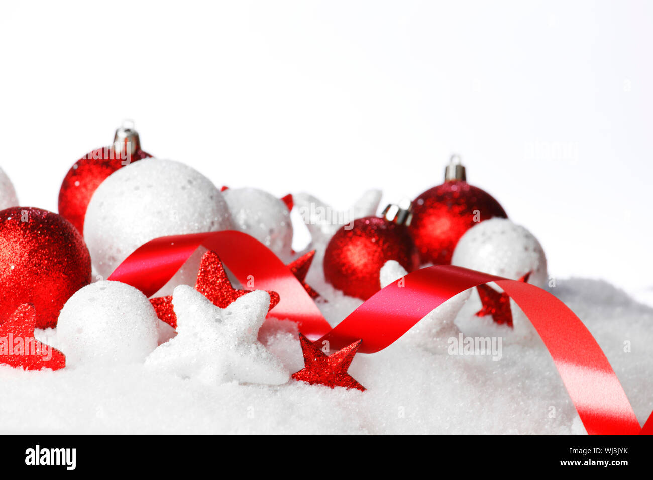 Beautiful red and white Christmas decoration with snow Stock Photo - Alamy