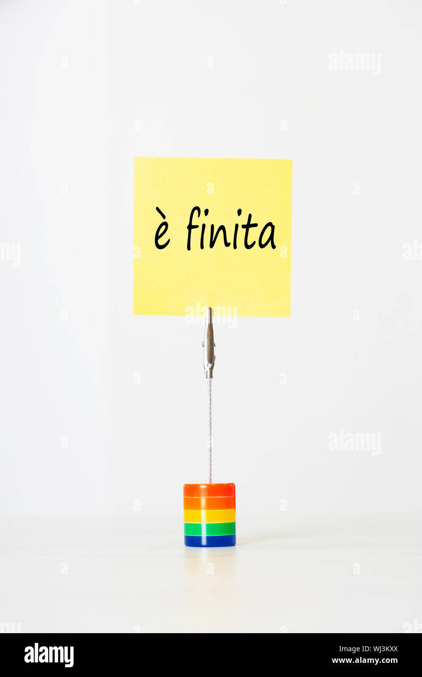Sticky notepaper with Italian text meaning It's over clipped to a ...
