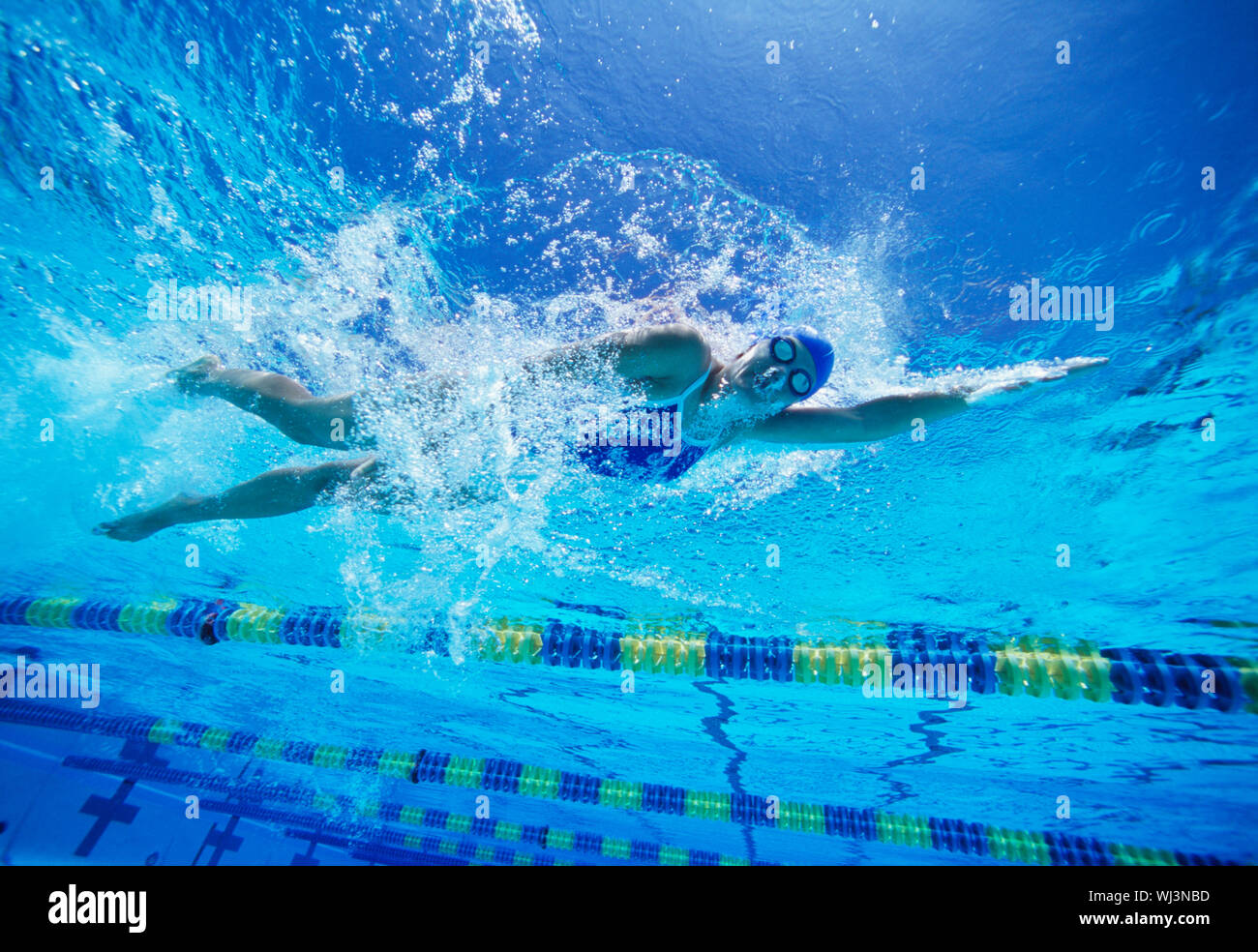 Women swimming in pool with blue cap hi-res stock photography and ...