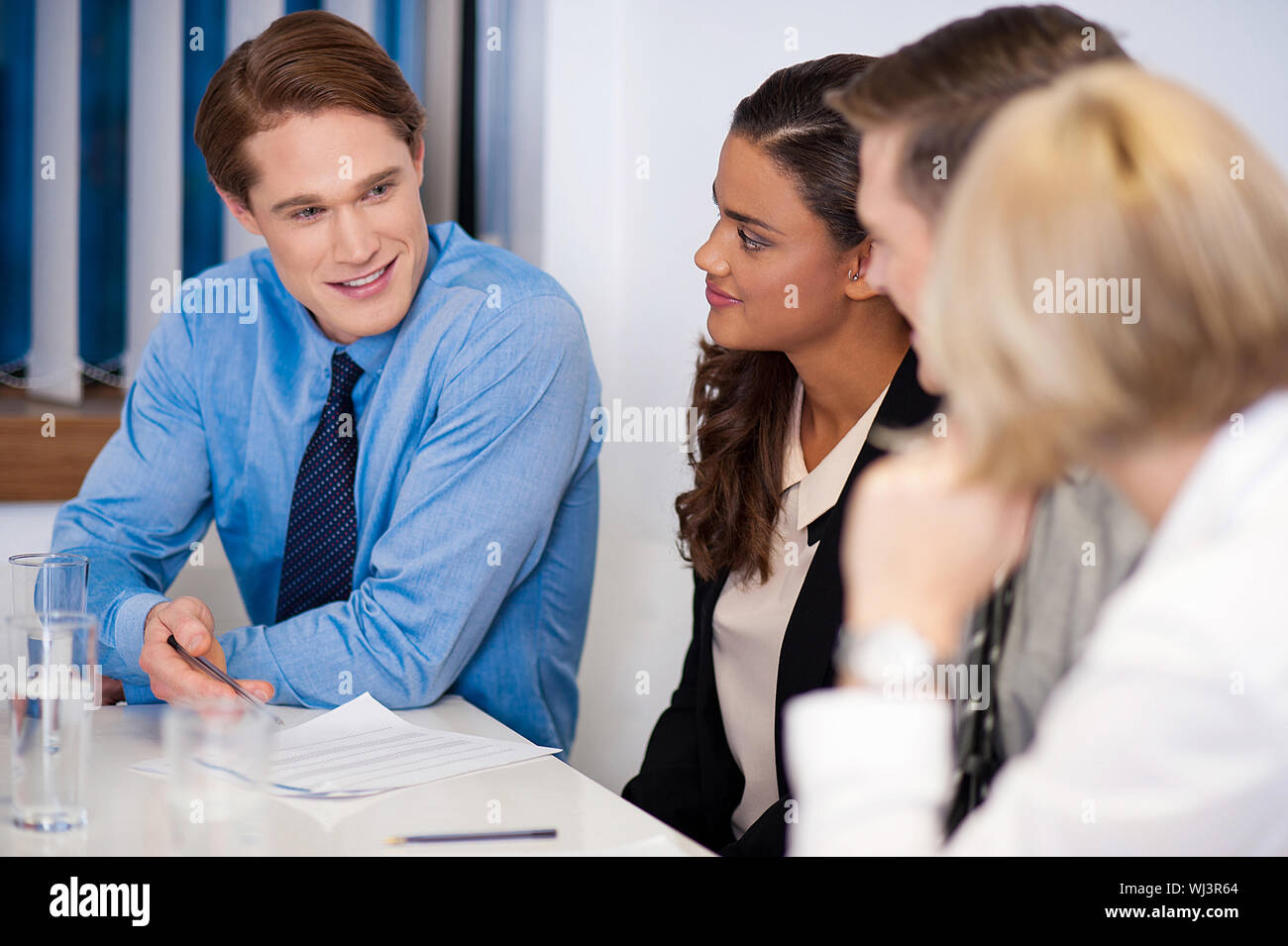 Team of friendly business people at work Stock Photo - Alamy