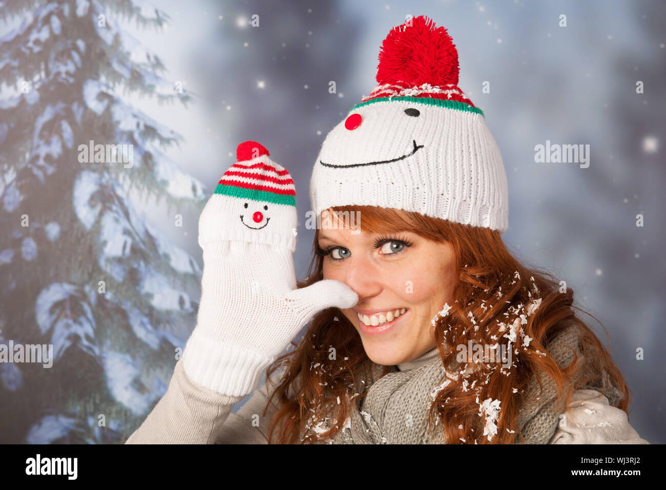 Portrait of woman in winter with snow and snowman hat Stock Photo - Alamy