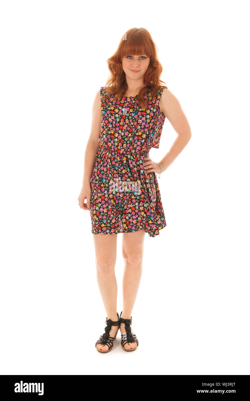 Attractive red haired girl standing in studio isolated over white ...