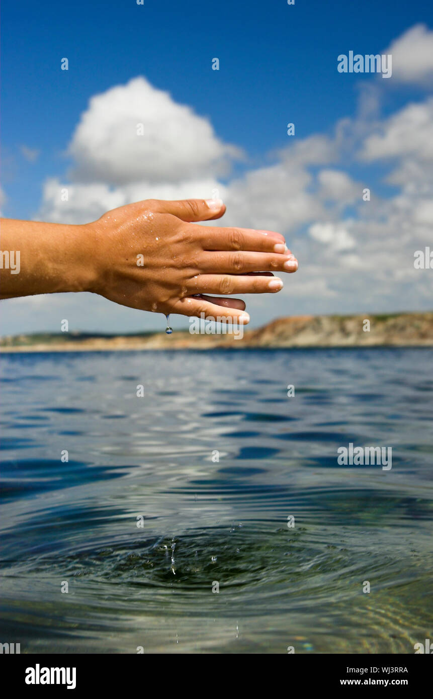 Close up of woman hands catching water from the ocean Stock Photo - Alamy