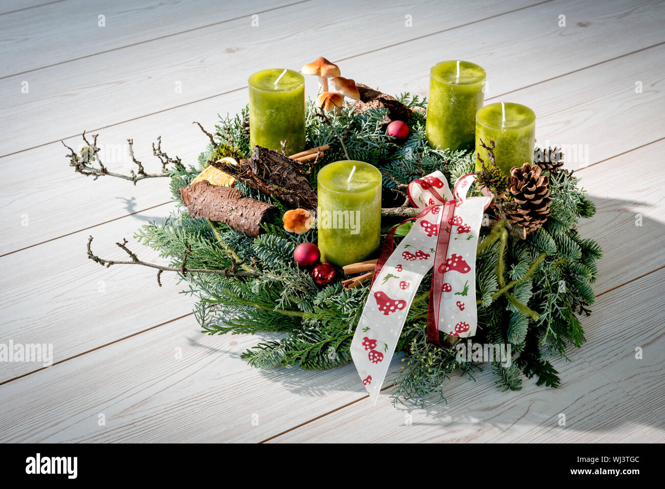 Advent wreath of twigs with green candles and various ornaments Stock ...
