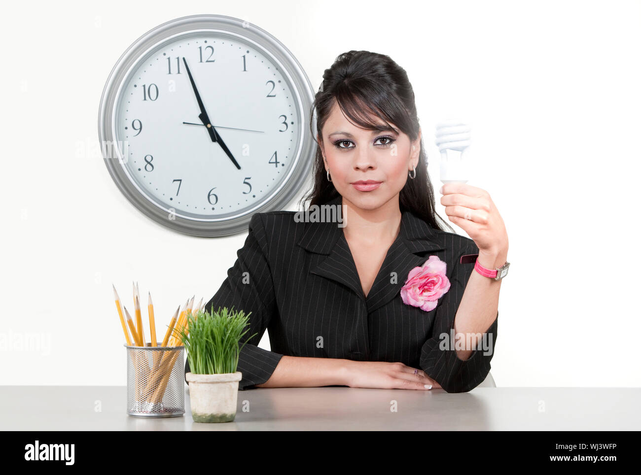 Pretty young woman holding glowing energy efficient lightbulb Stock ...