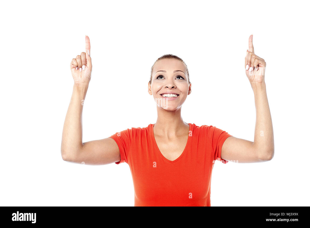 Attractive young woman pointing upwards Stock Photo - Alamy