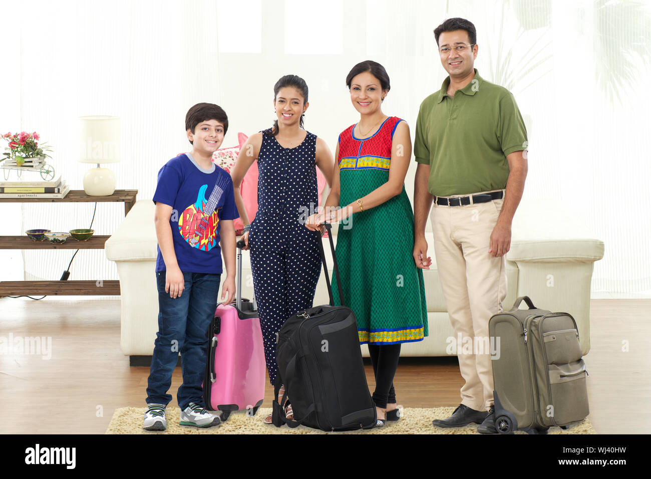Man woman couple family girl daughter parents luggage hi-res stock ...