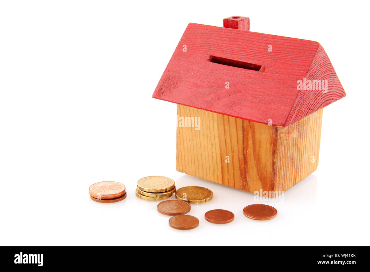 Buying a house with coins isolated over white Stock Photo - Alamy